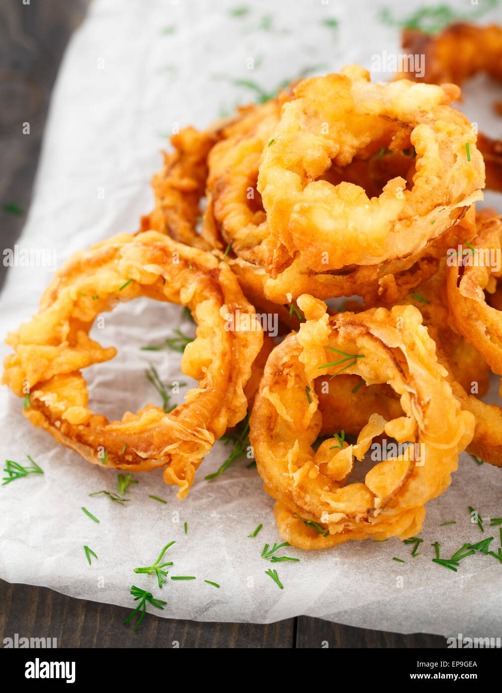 Homemade crunchy fried onion rings on a parchment Stock Photo - Alamy