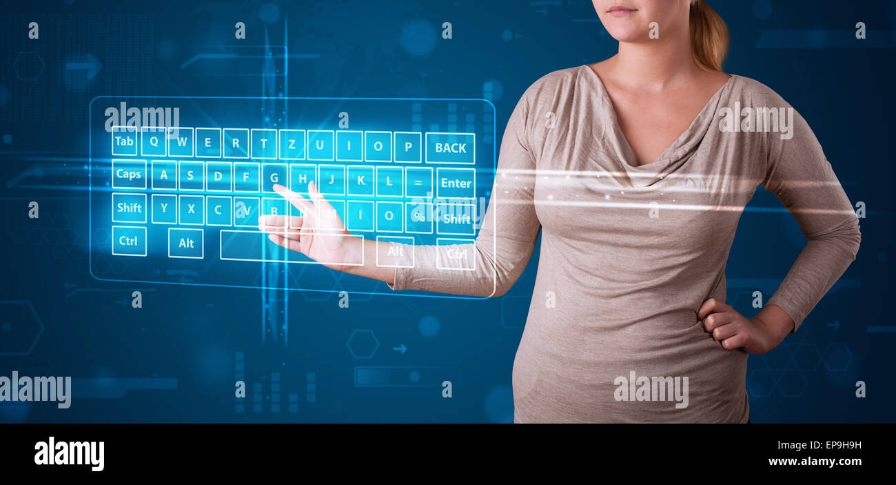 Girl pressing virtual type of keyboard Stock Photo - Alamy