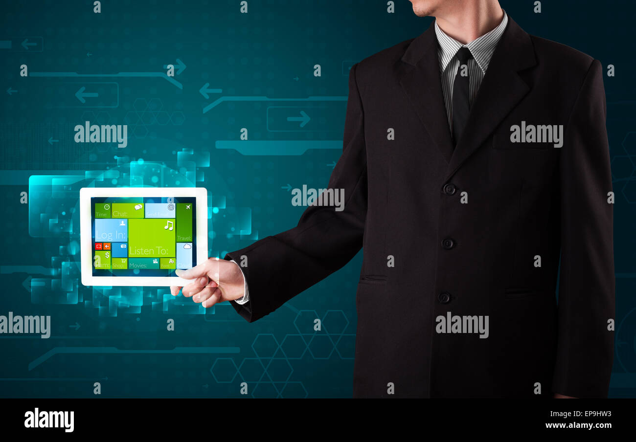 Businessman holding a tablet with modern software operational system ...