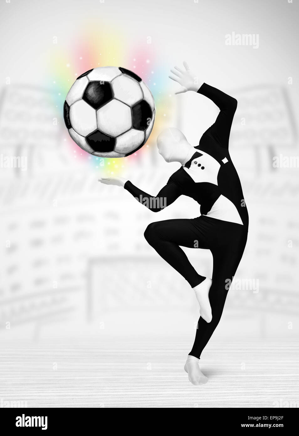 man in full body suit holdig soccer ball Stock Photo - Alamy