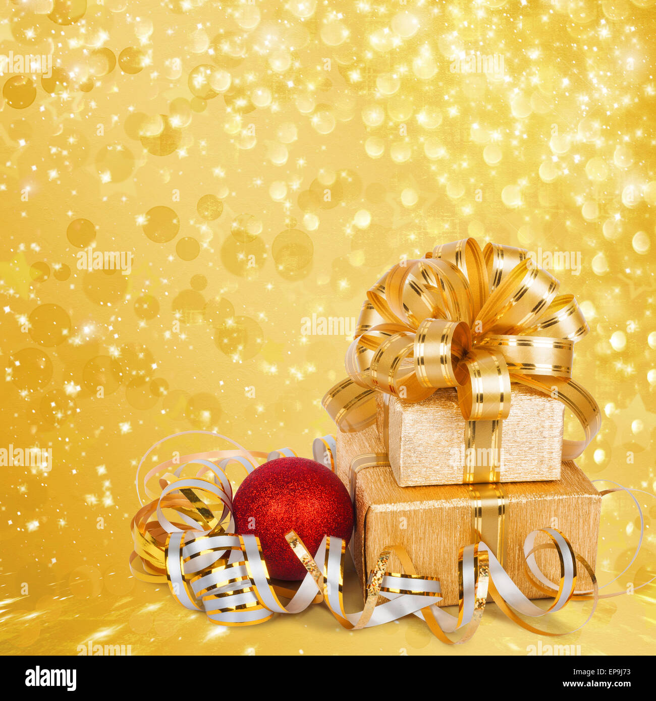 Gift box in gold wrapping paper on a beautiful abstract background ...
