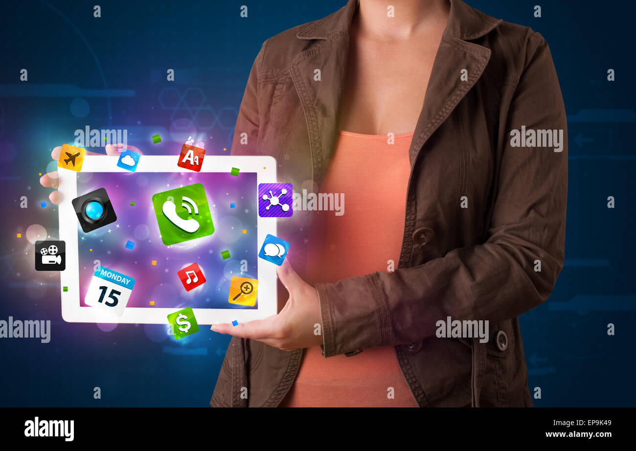Lady holding a tablet with modern colorful apps and icons Stock Photo ...