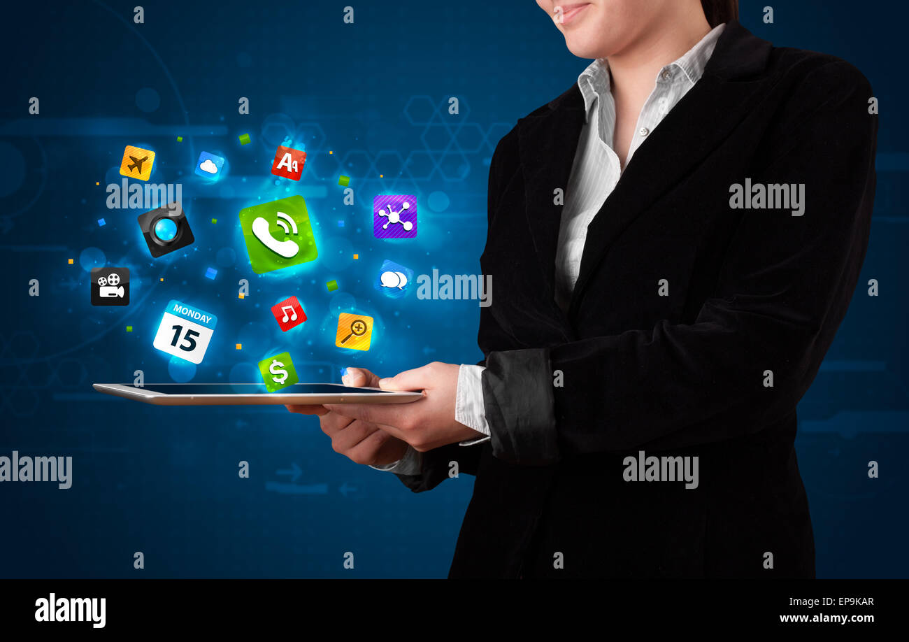 Lady holding a tablet with modern colorful apps and icons Stock Photo ...
