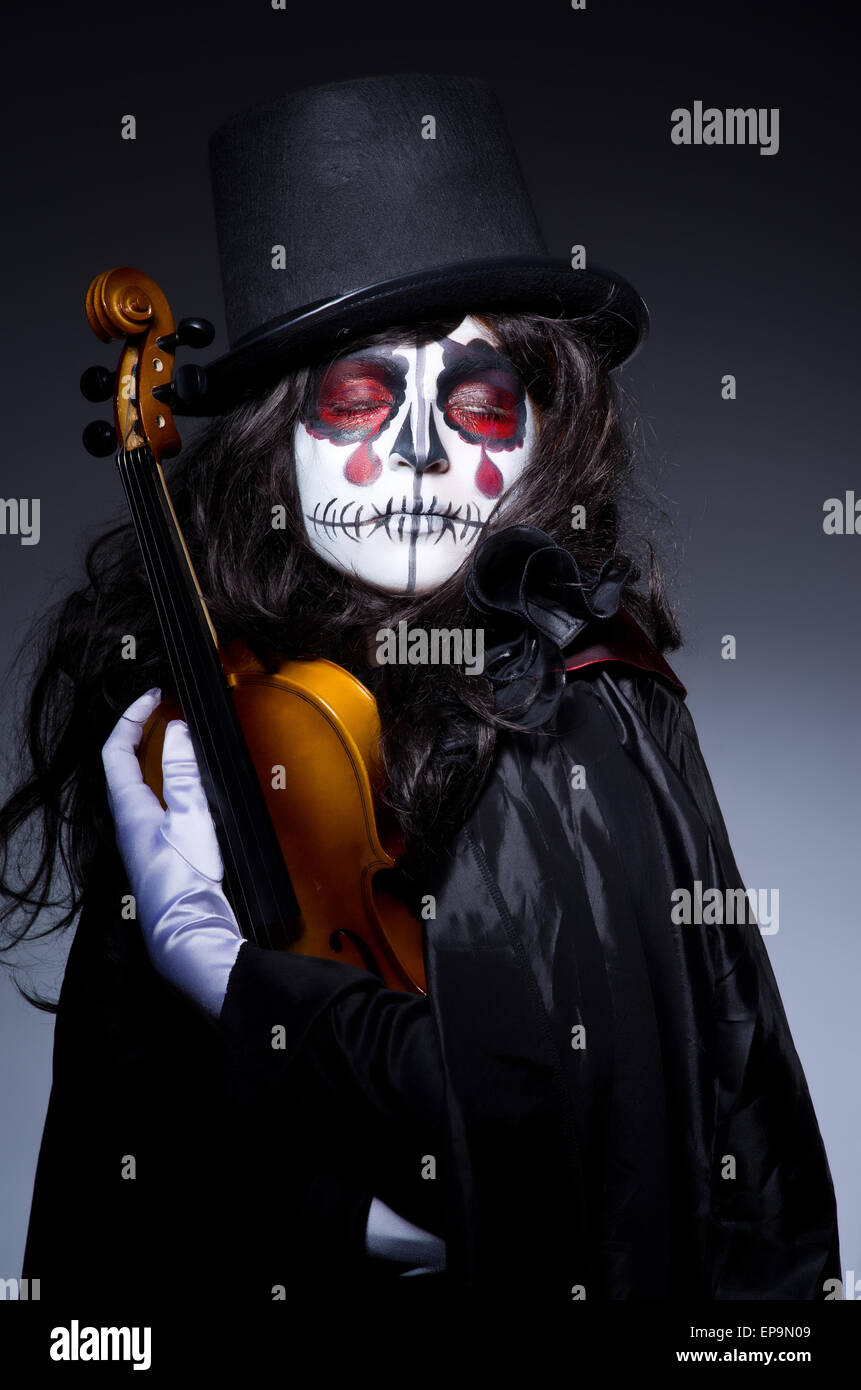 Monster playing violin in dark room Stock Photo - Alamy