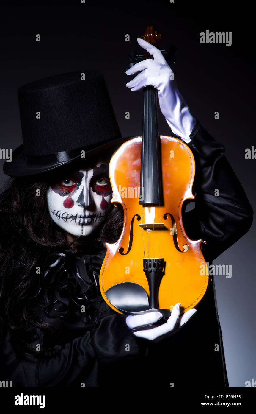 Monster playing violin in dark room Stock Photo - Alamy