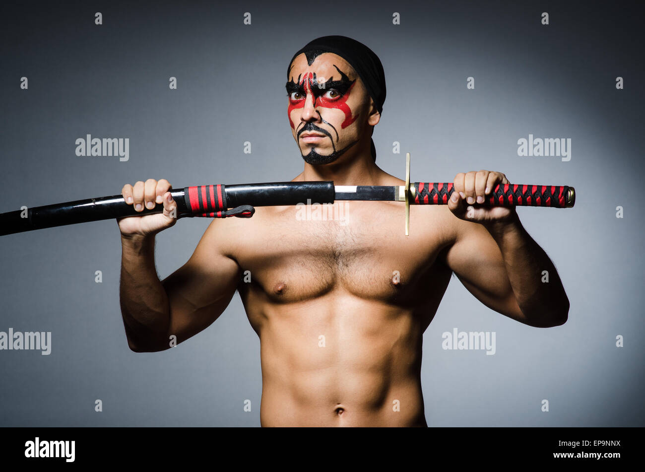 Man with sword and face paint Stock Photo - Alamy