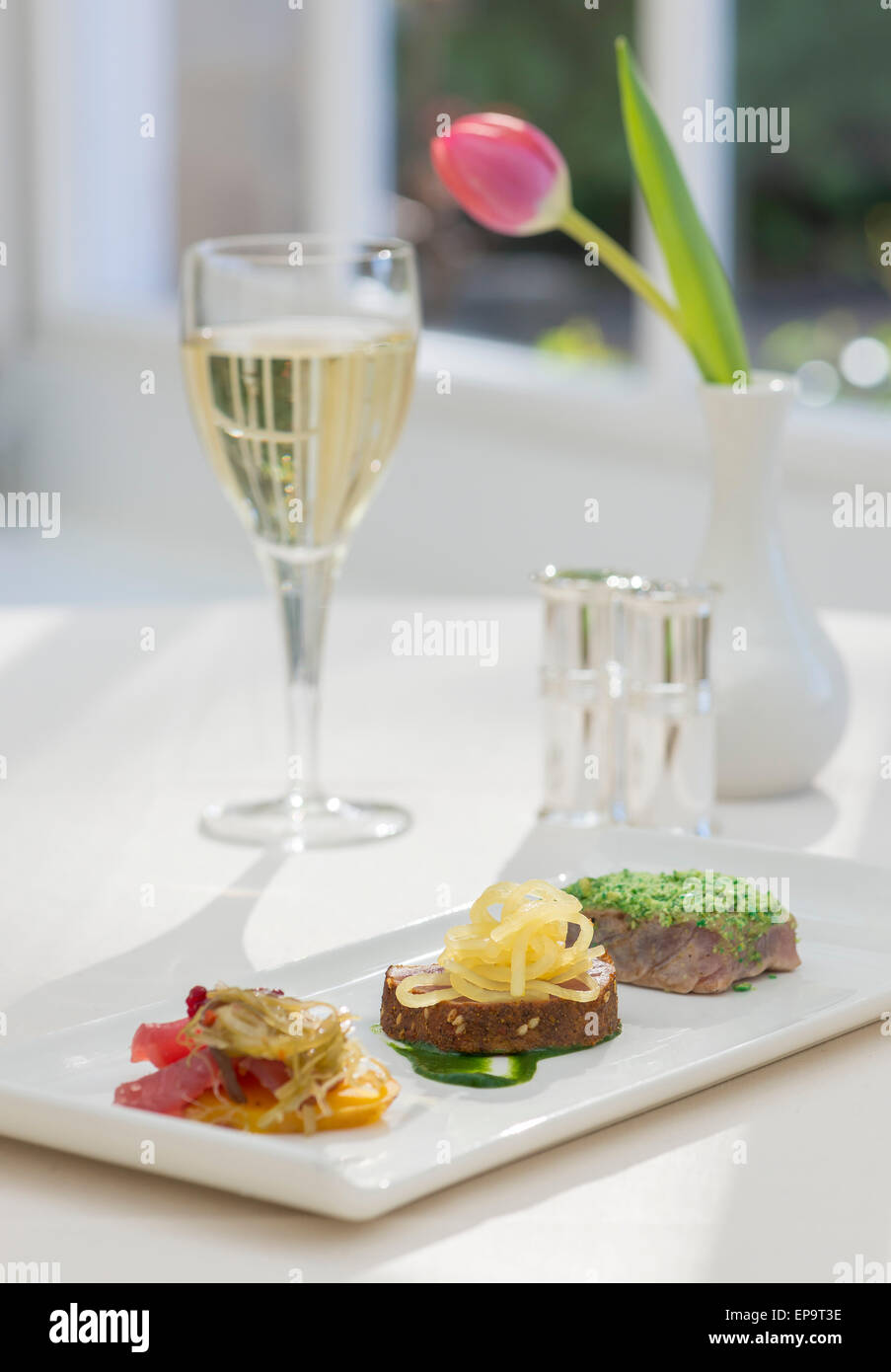 Trio of Tuna served with white wine in a restaurant setting Stock Photo ...