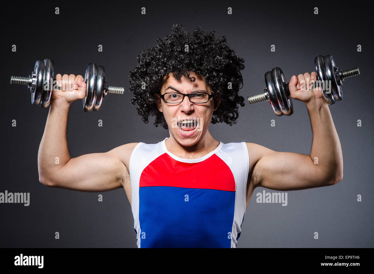 Funny man exercising with dumbbells Stock Photo - Alamy