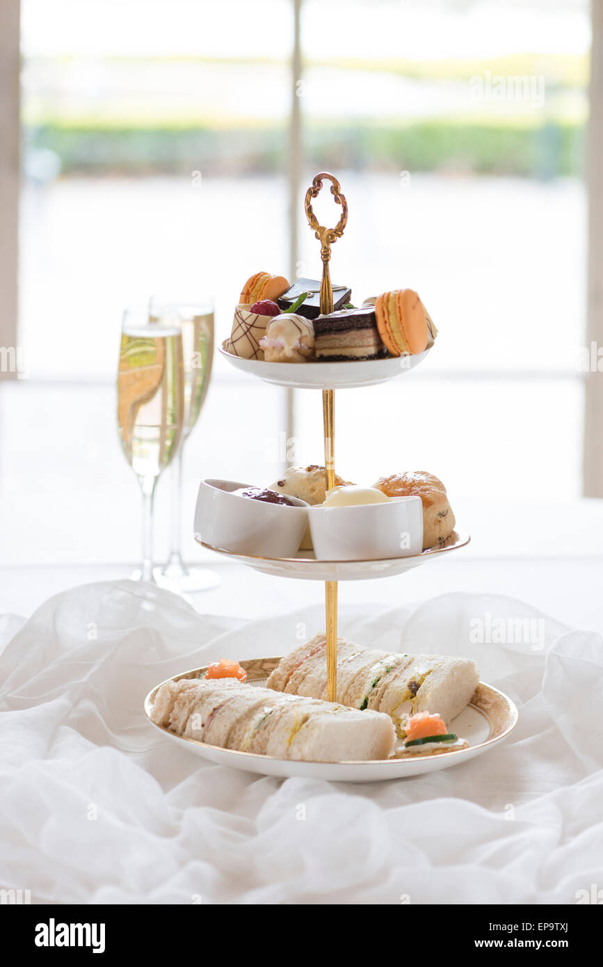 Afternoon tea with cakes, scones and finger sandwiches Stock Photo - Alamy