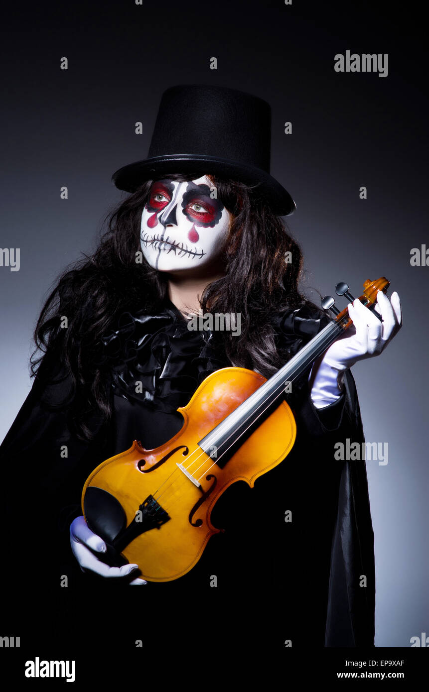 Monster playing violin in dark room Stock Photo - Alamy