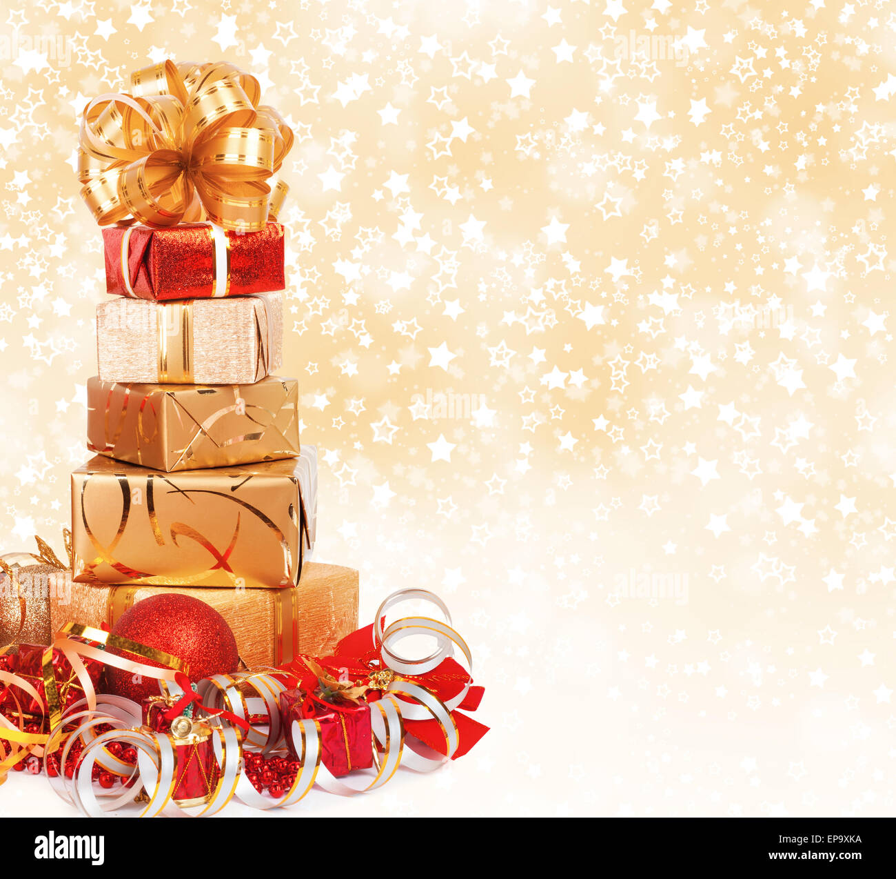 Gift box in gold wrapping paper on a beautiful abstract background ...