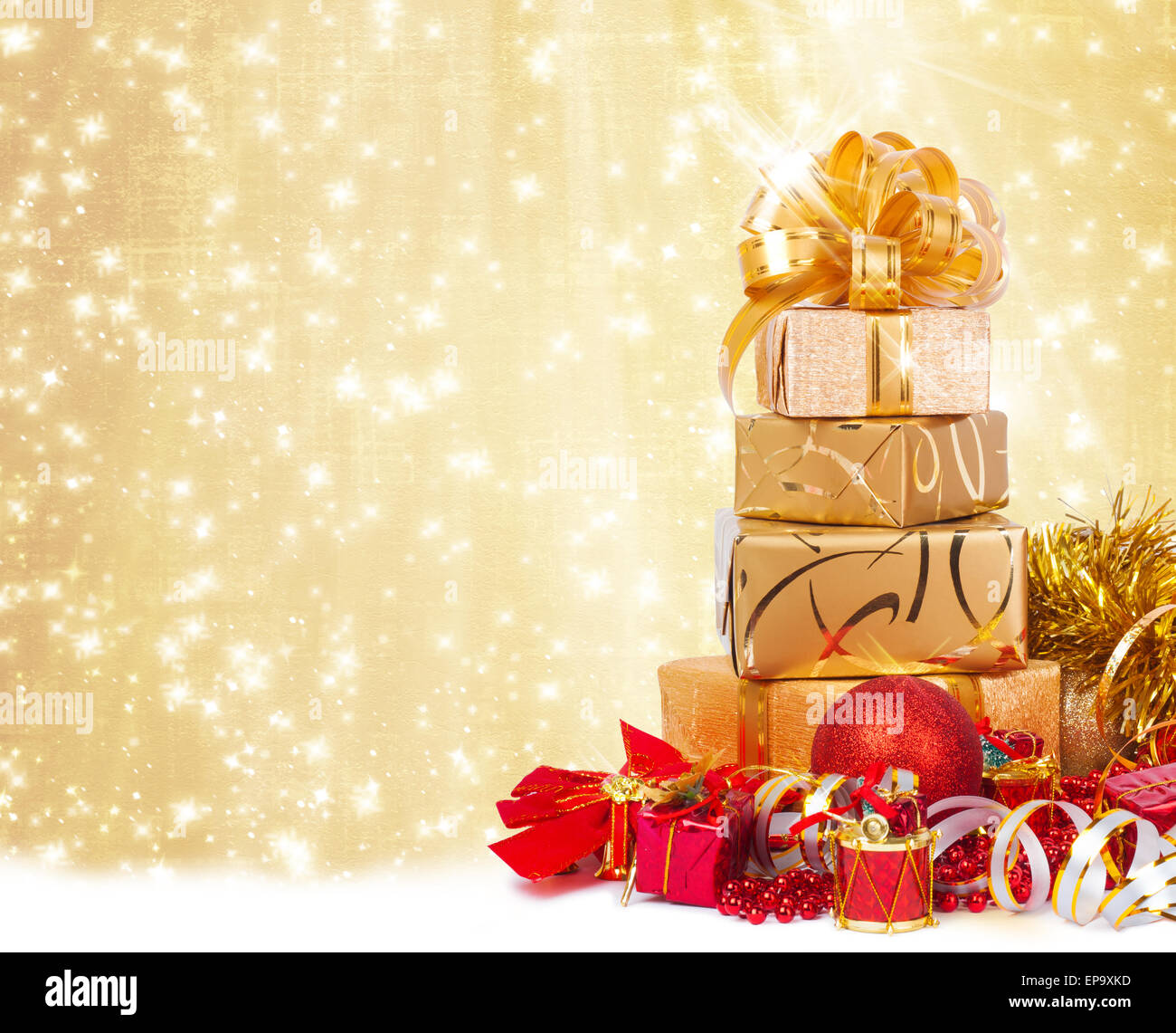 Gift box in gold wrapping paper on a beautiful abstract background ...