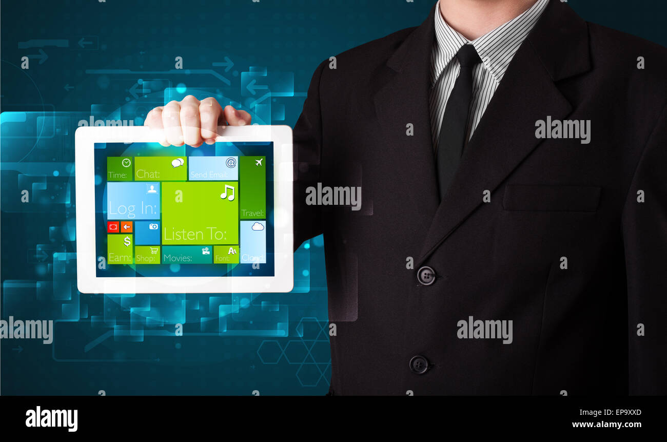 Businessman holding a tablet with modern software operational system ...