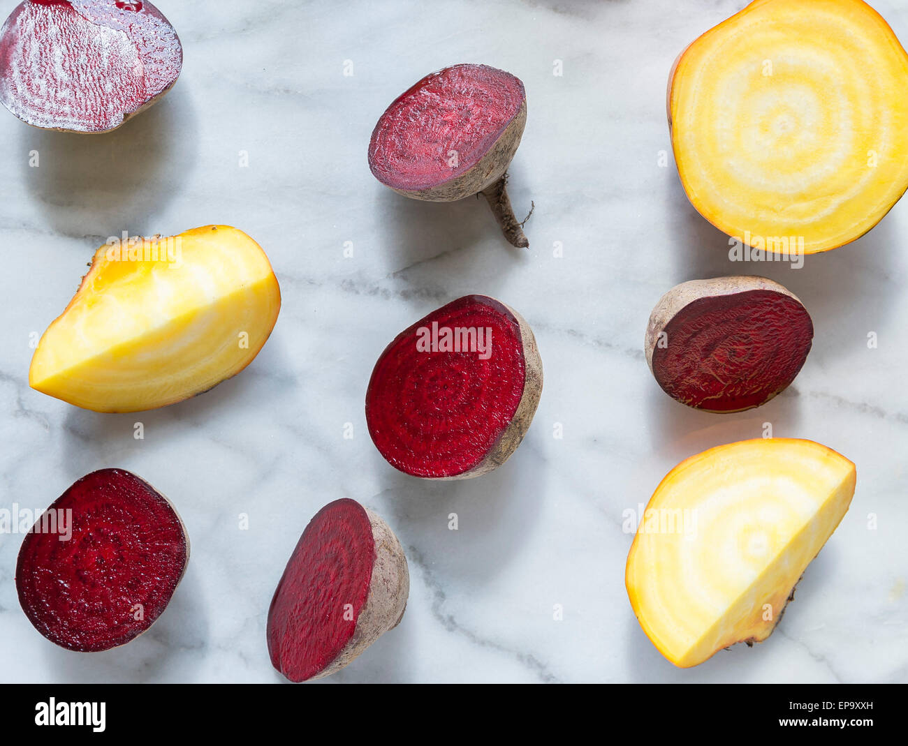 Red beetroot and golden beetroot on a marble chopping board Stock Photo ...