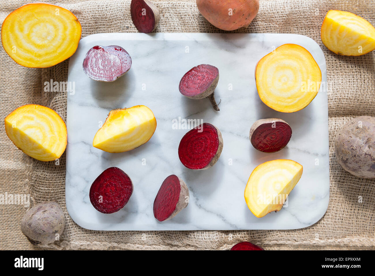 Red beetroot and golden beetroot on a marble chopping board Stock Photo ...