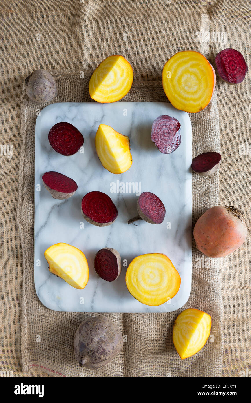 Red beetroot and golden beetroot on a marble chopping board Stock Photo ...