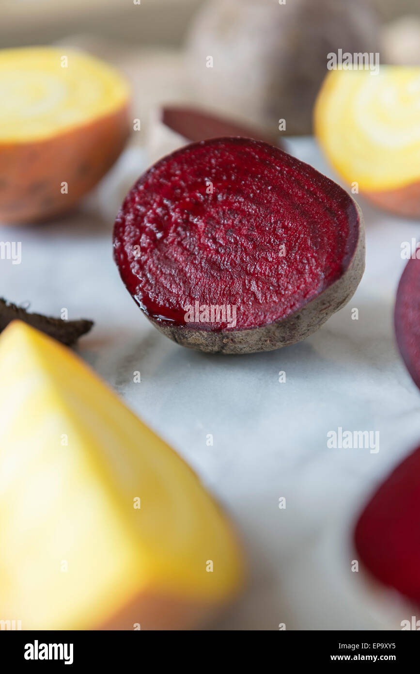 Red beetroot and golden beetroot on a marble chopping board Stock Photo ...