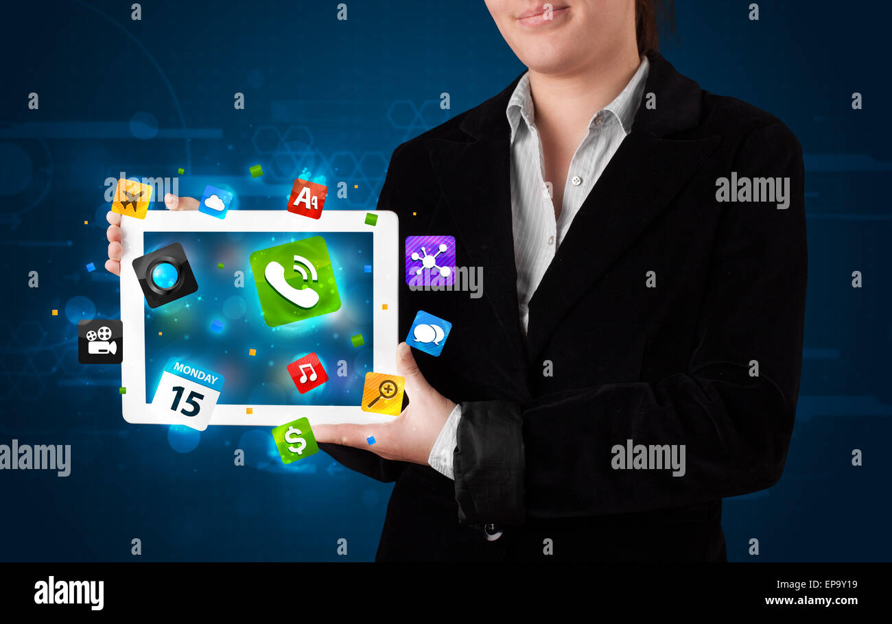 Lady holding a tablet with modern colorful apps and icons Stock Photo ...
