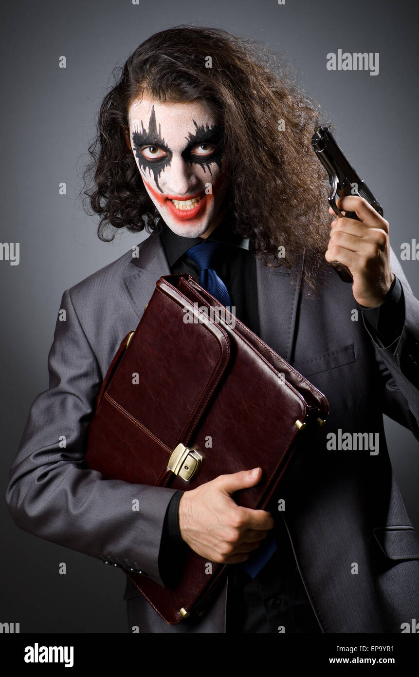 Joker with gun and briefcase Stock Photo - Alamy