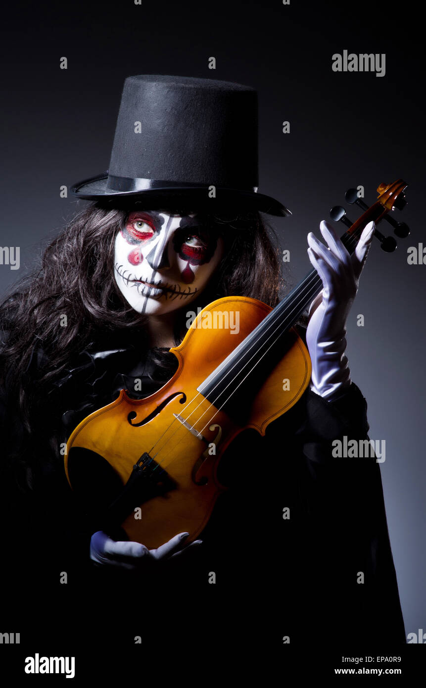 Monster playing violin in dark room Stock Photo - Alamy