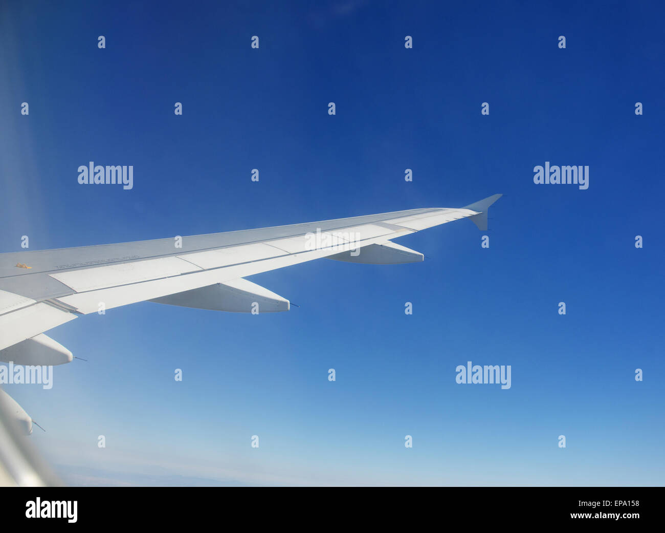 Airplane wing out of window Stock Photo - Alamy