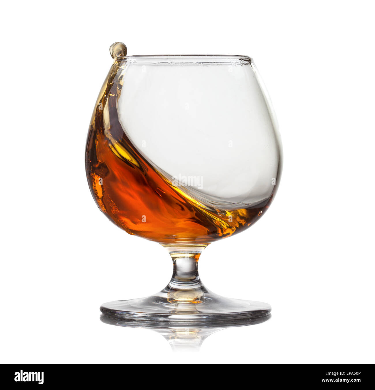 Splash of cognac in glass isolated on white background Stock Photo - Alamy
