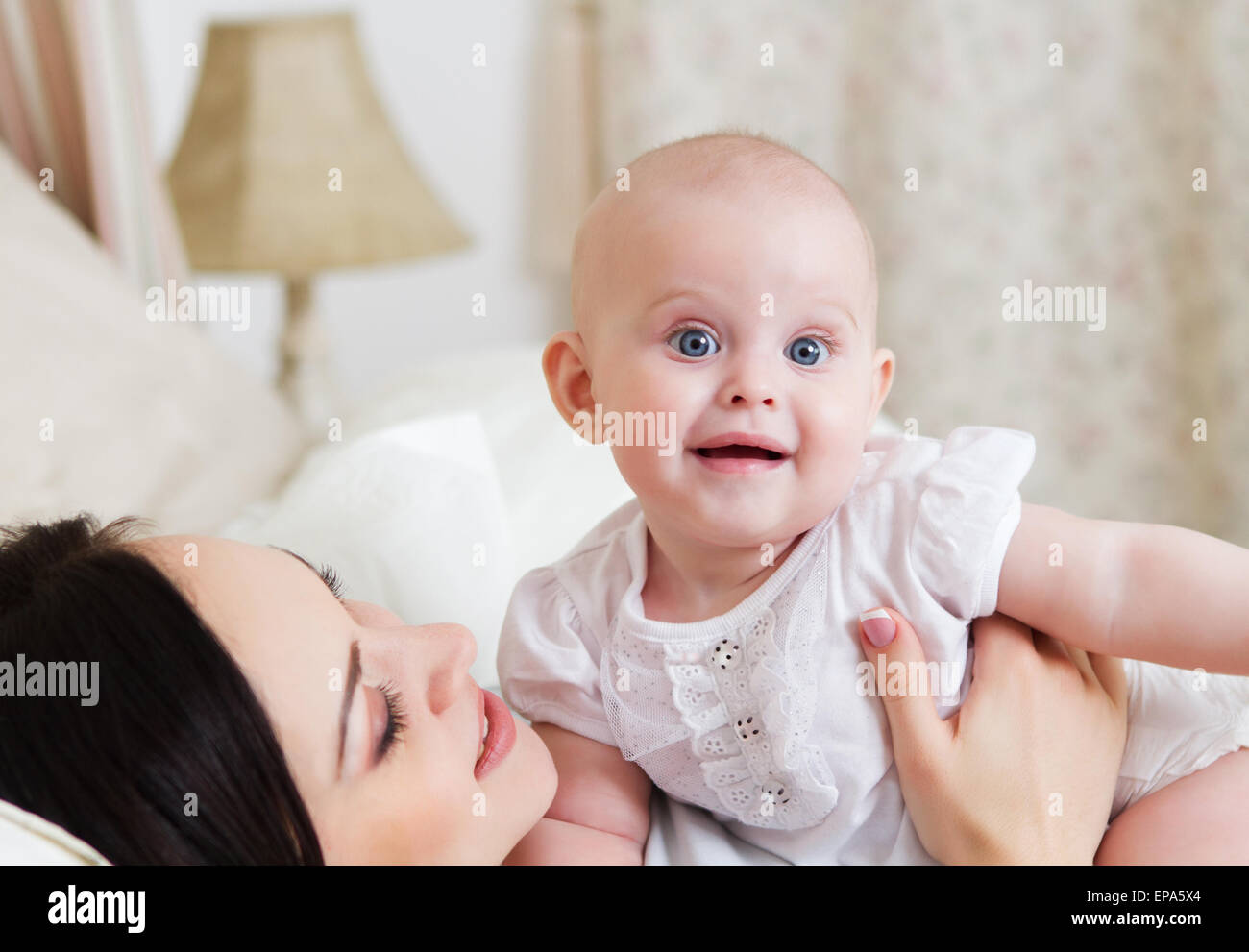 Happy smiling mother with six month old baby girl Stock Photo - Alamy