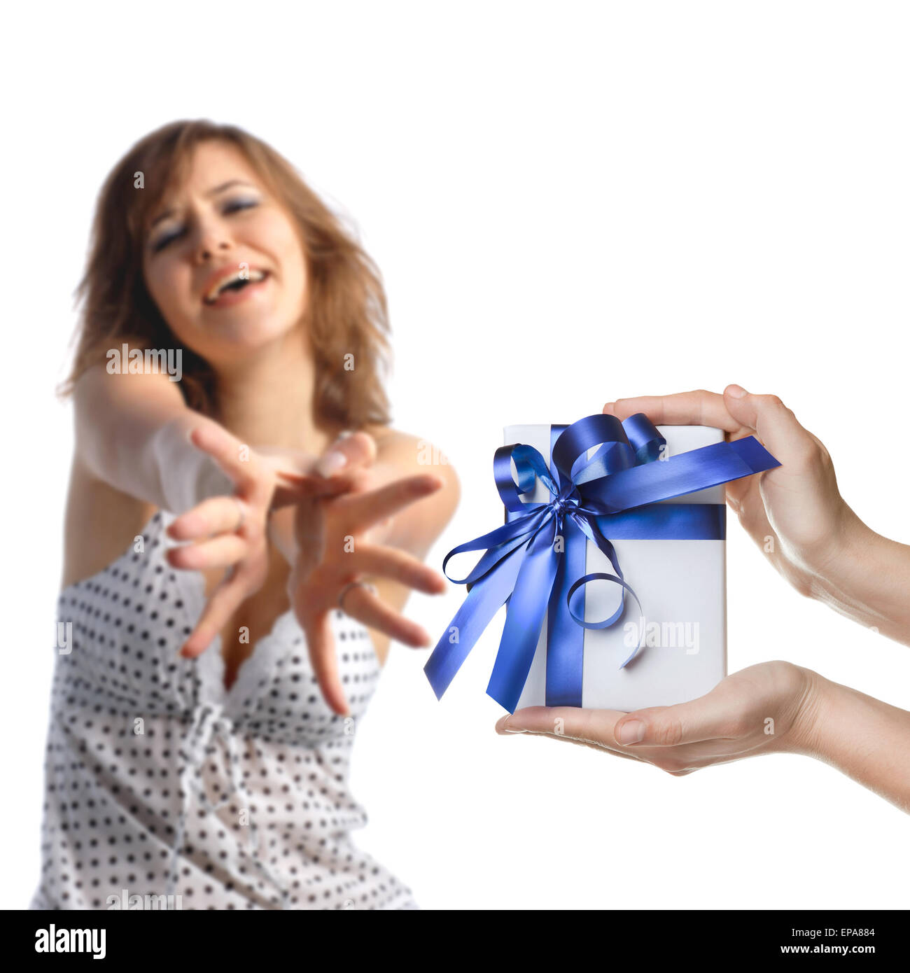 A girl reaching out for men's hands holding a present on white ...