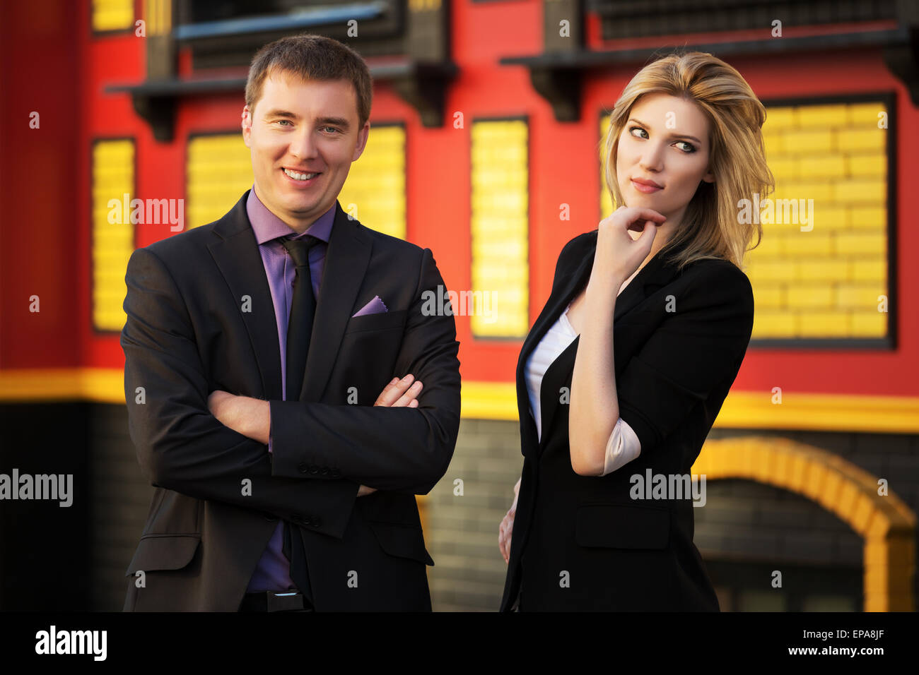 Young business couple against office building Stock Photo - Alamy