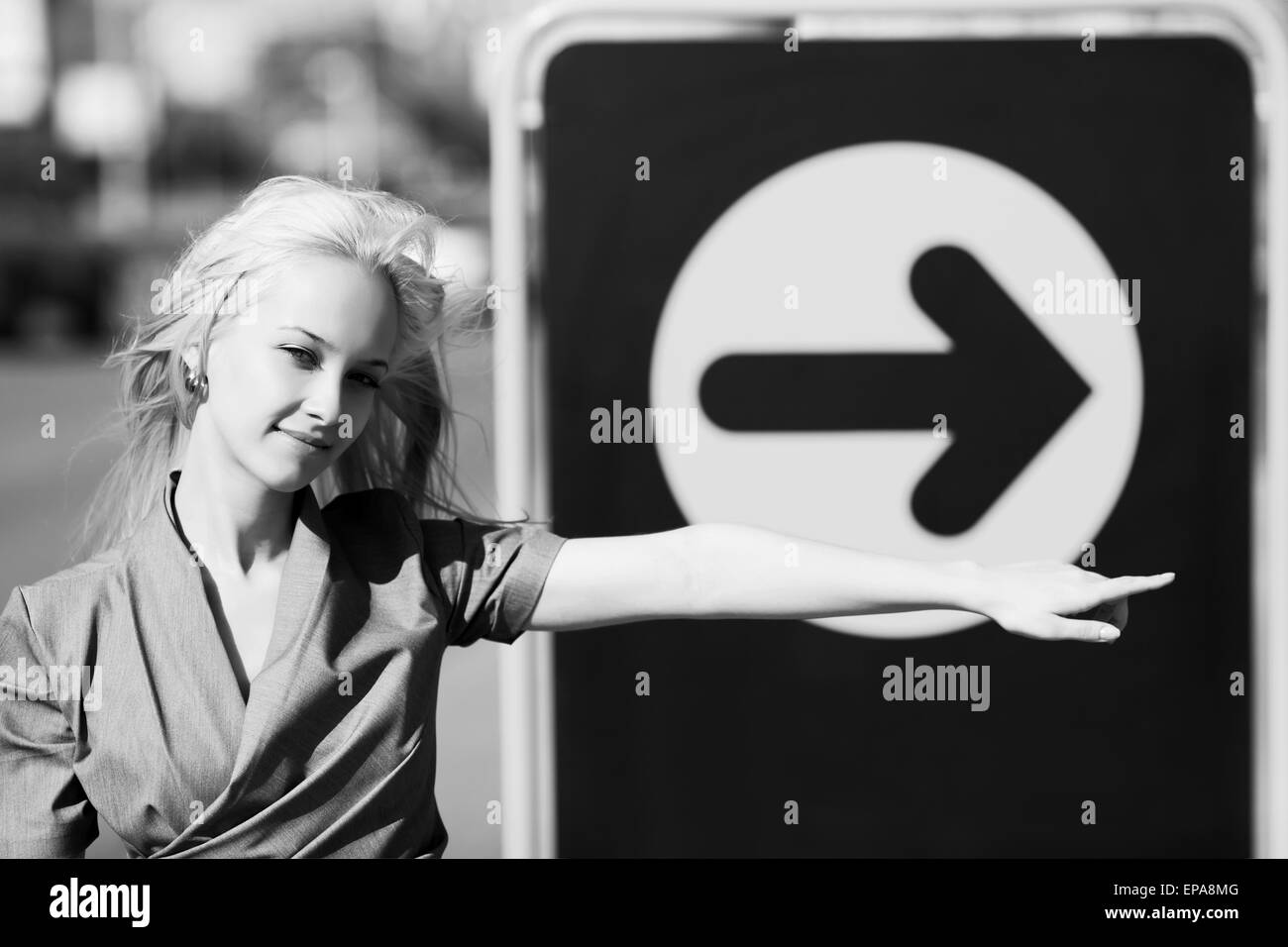 Young woman pointing a direction Stock Photo - Alamy