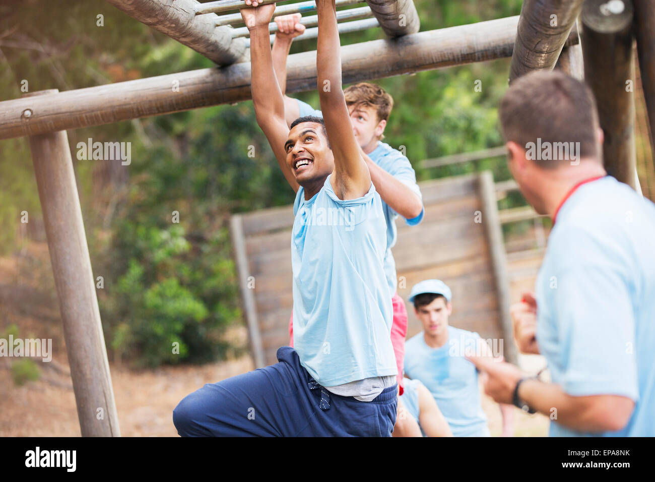 man monkey bars boot camp obstacle course Stock Photo - Alamy