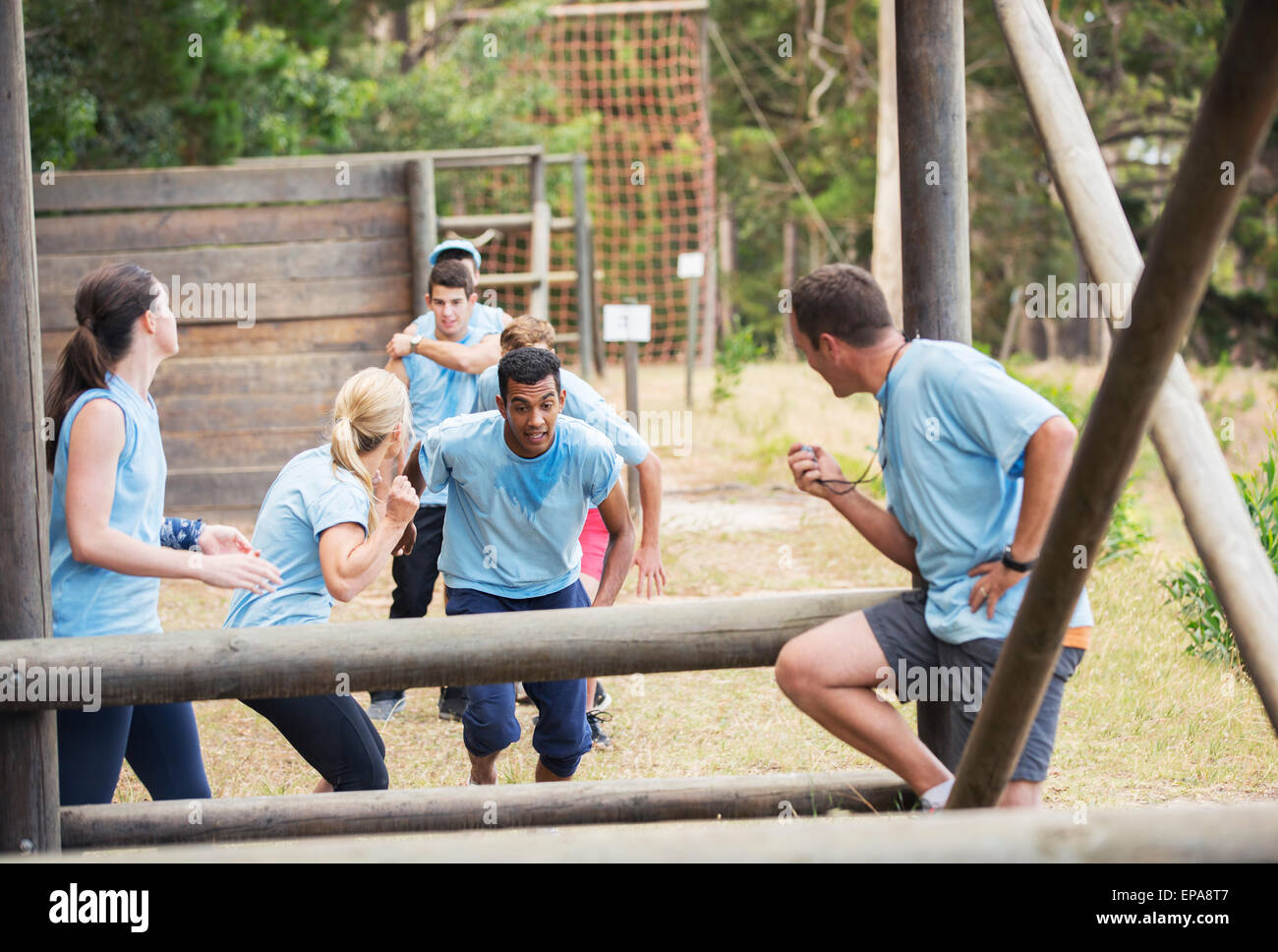 cheering man boot camp obstacle course Stock Photo - Alamy