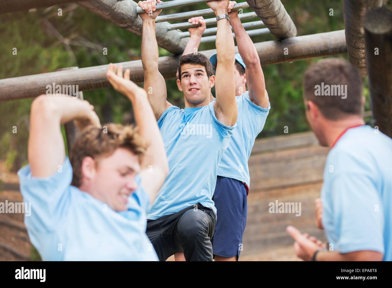 man monkey bars boot camp obstacle course Stock Photo - Alamy