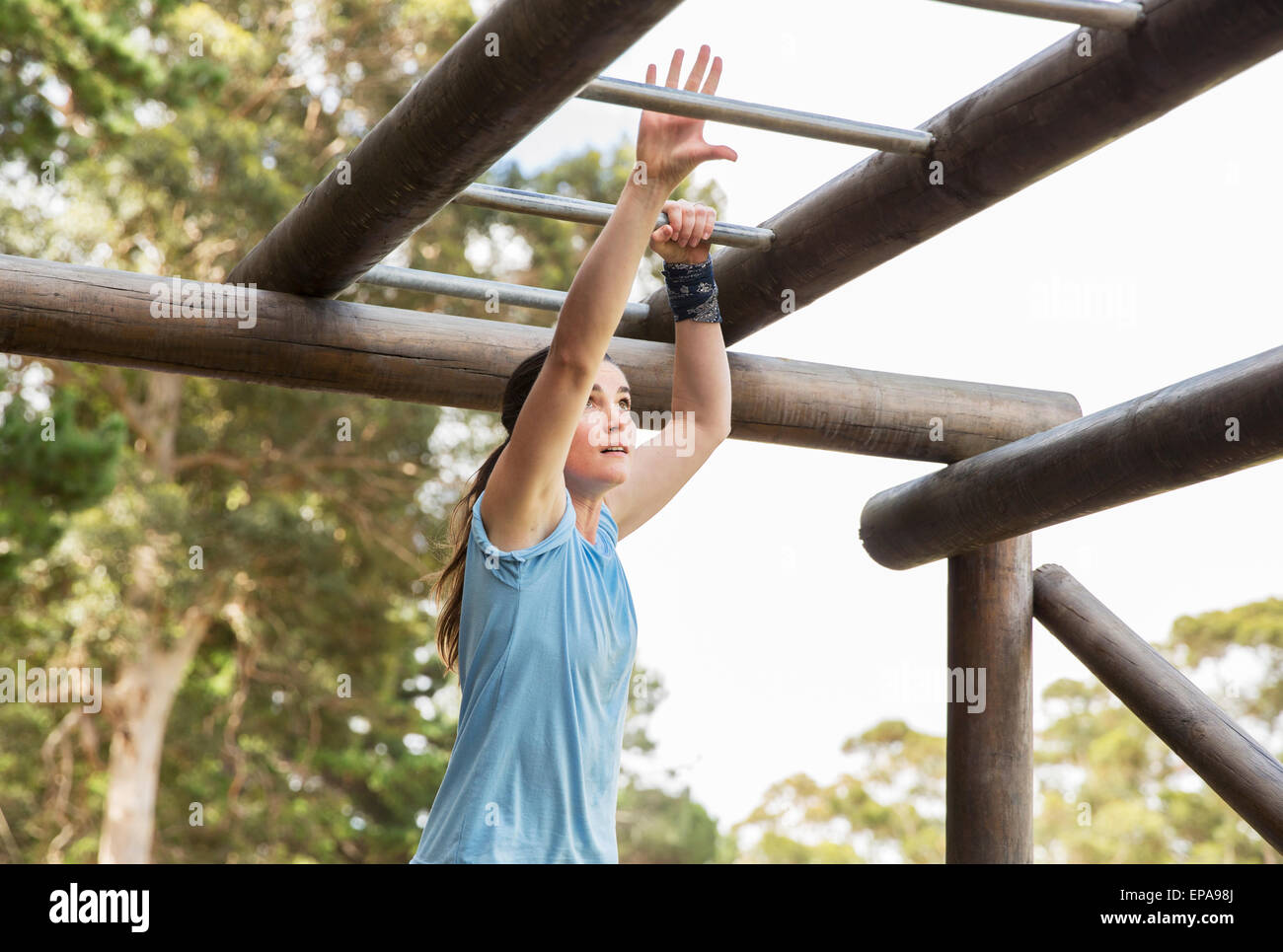 woman monkey bars boot camp obstacle course Stock Photo - Alamy