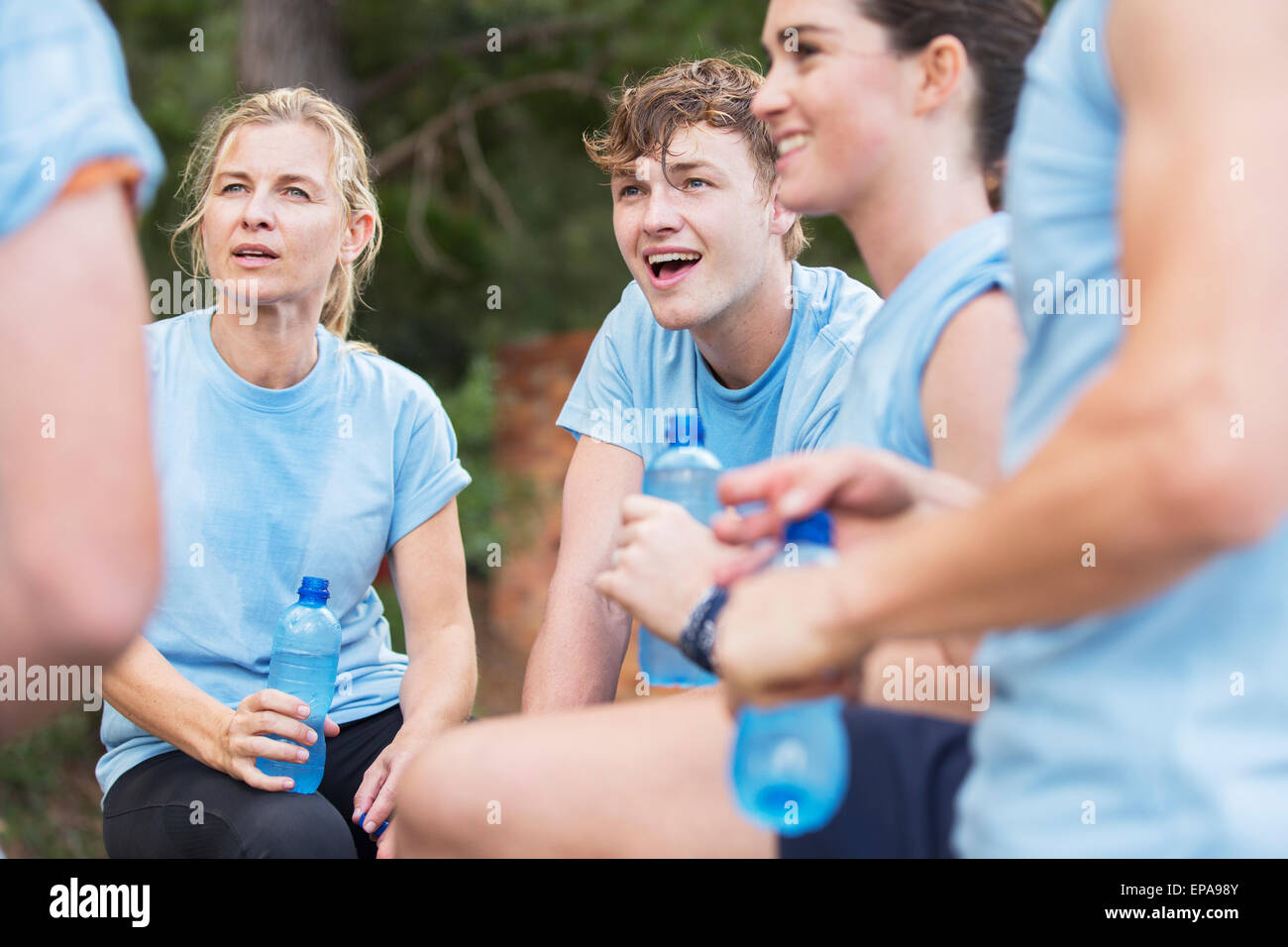 tired team resting drinking water boot camp Stock Photo - Alamy