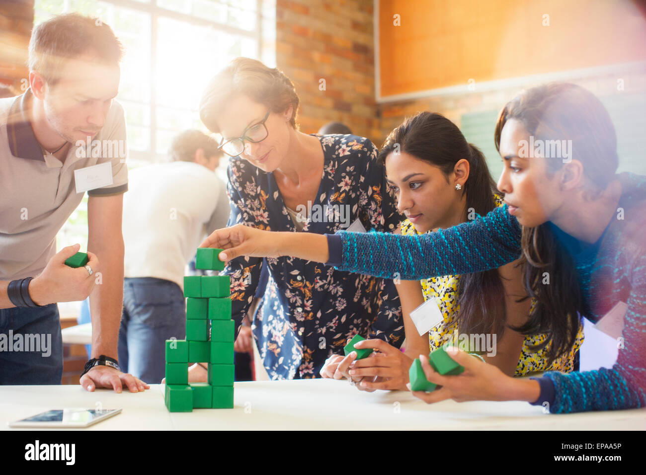 creative business people stacking green block Stock Photo - Alamy