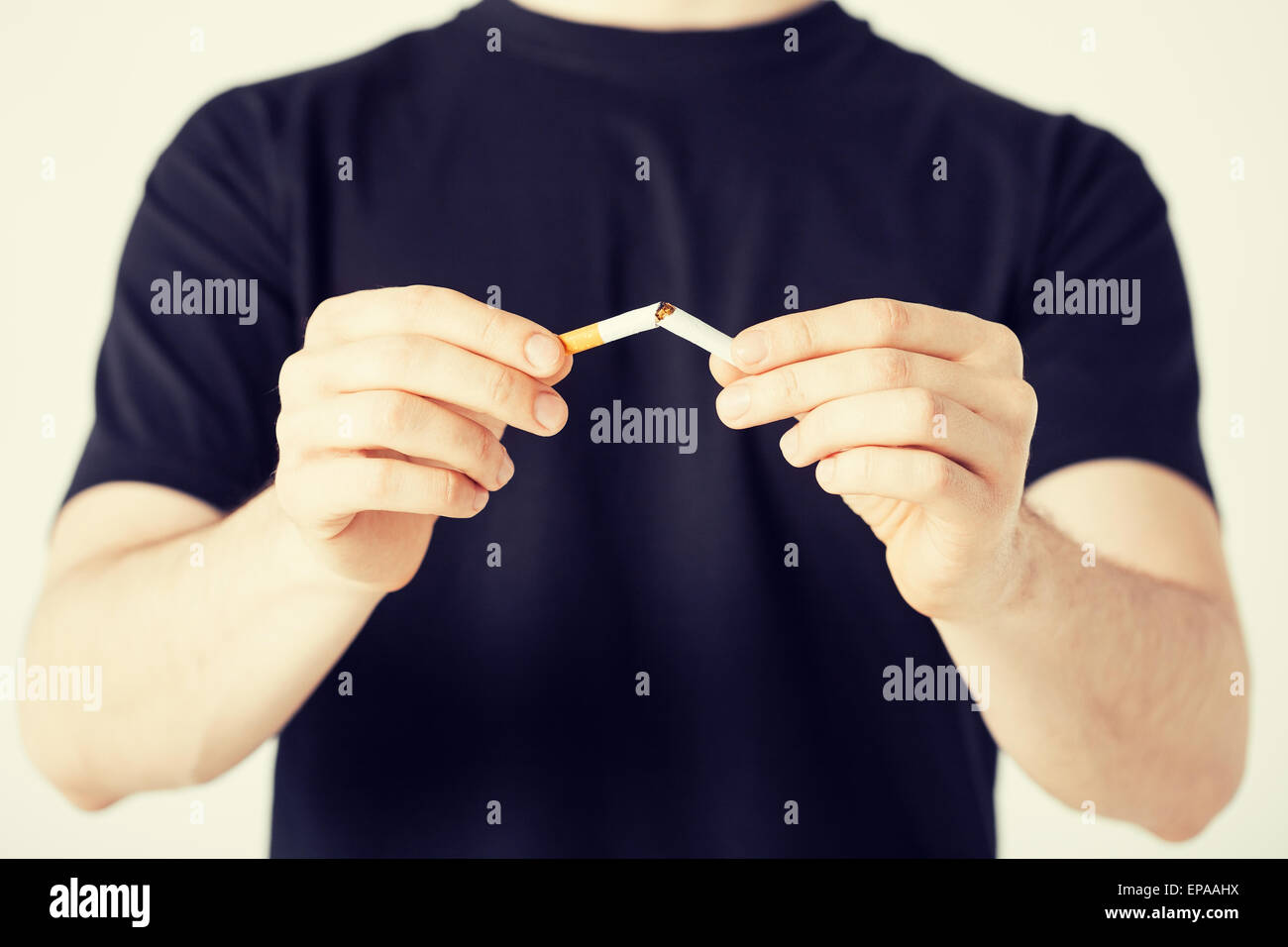 man breaking the cigarette with hands Stock Photo - Alamy