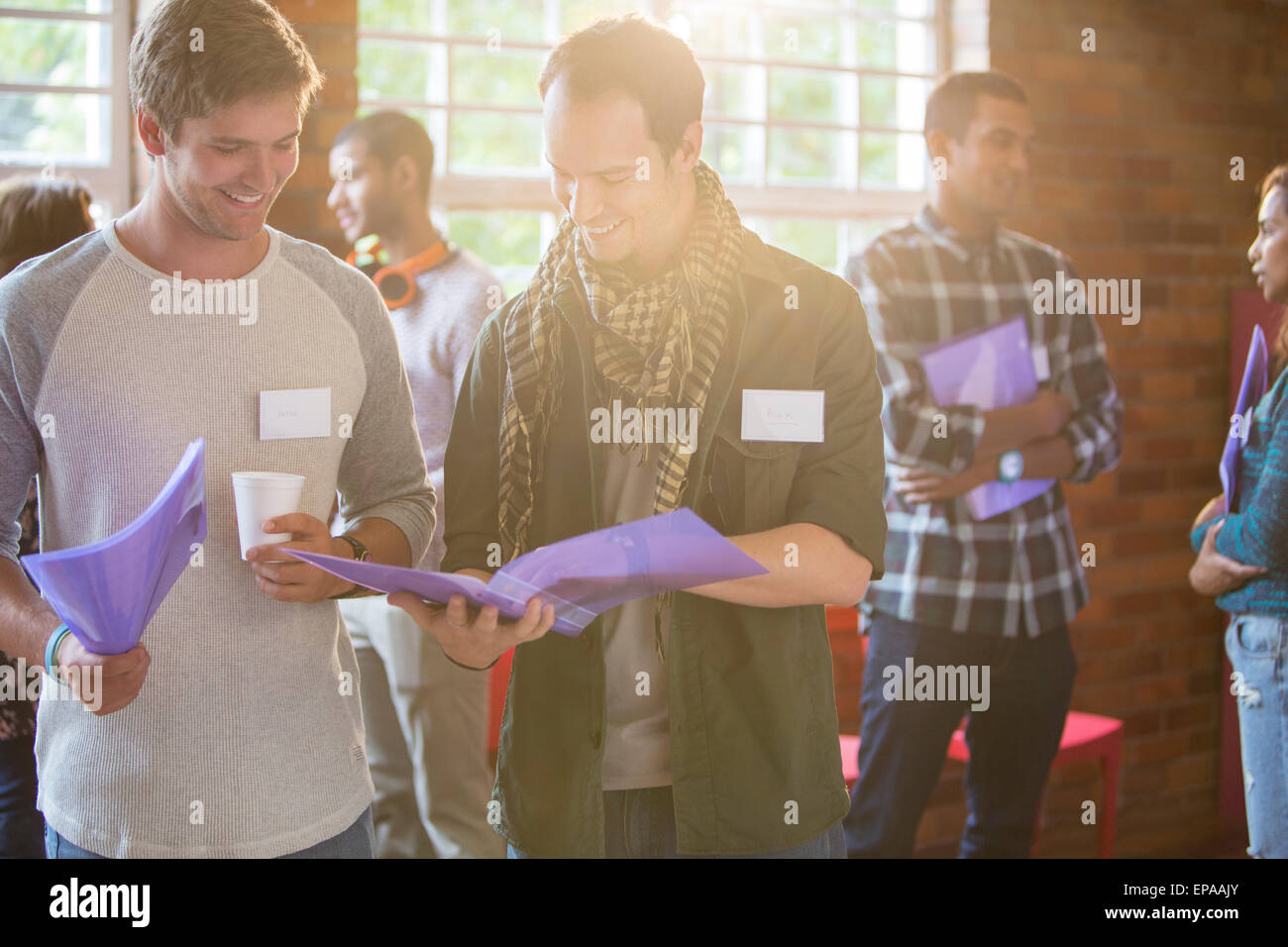 man reading paperwork Community center Stock Photo - Alamy
