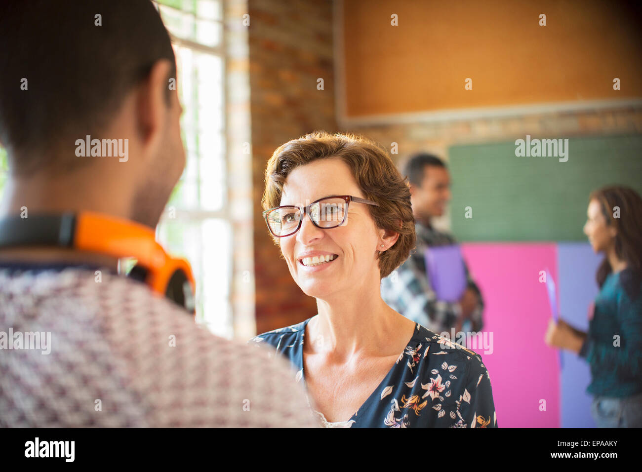 people talking Community center Stock Photo - Alamy