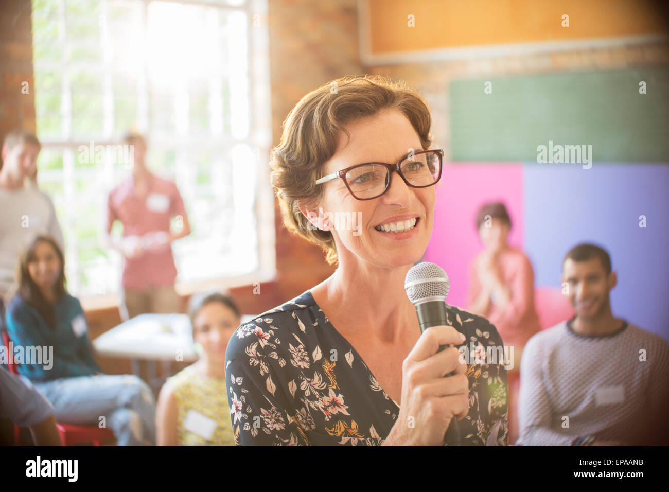 audience speaker microphone community center Stock Photo - Alamy