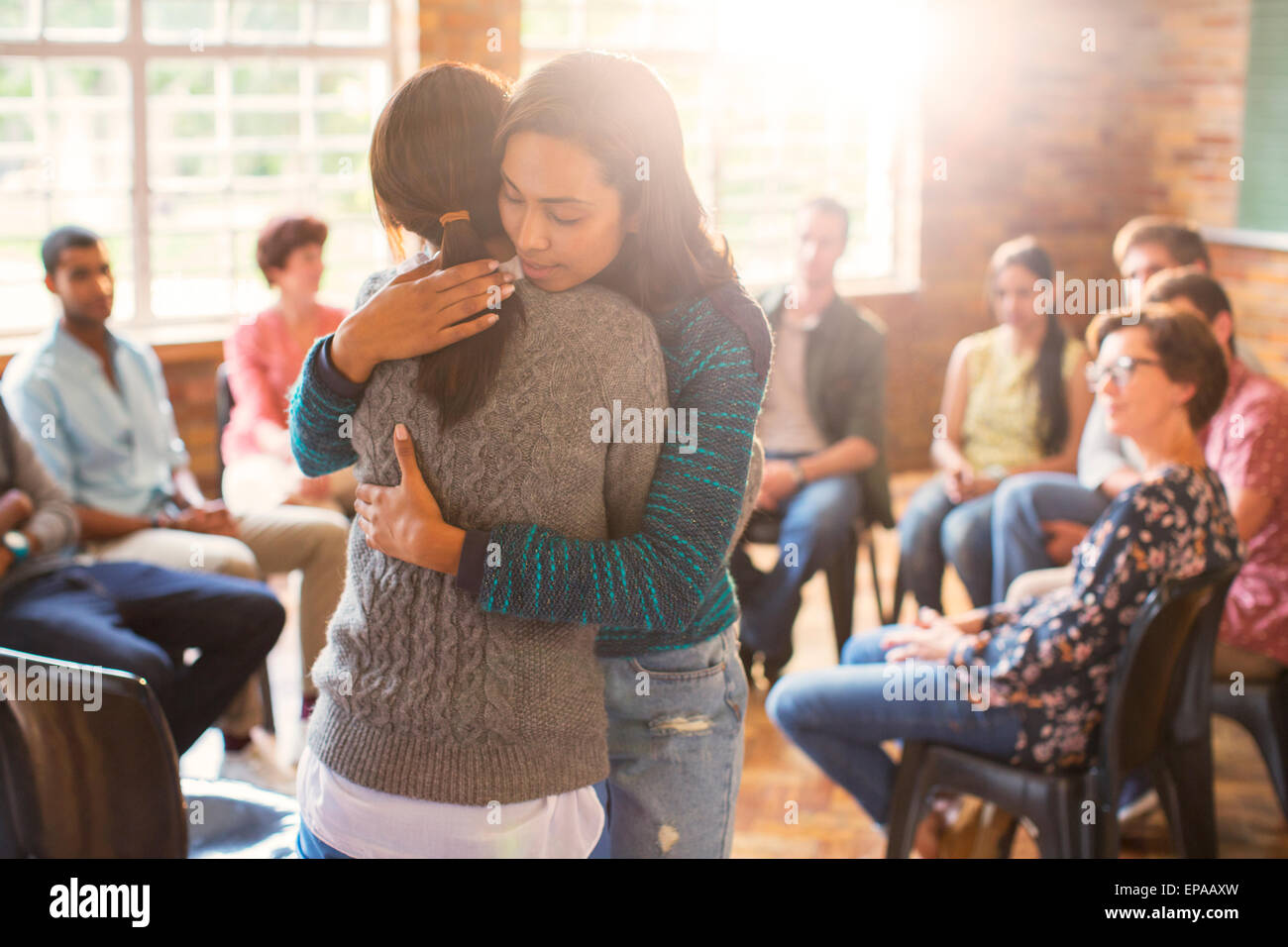woman hugging group therapy session Stock Photo - Alamy