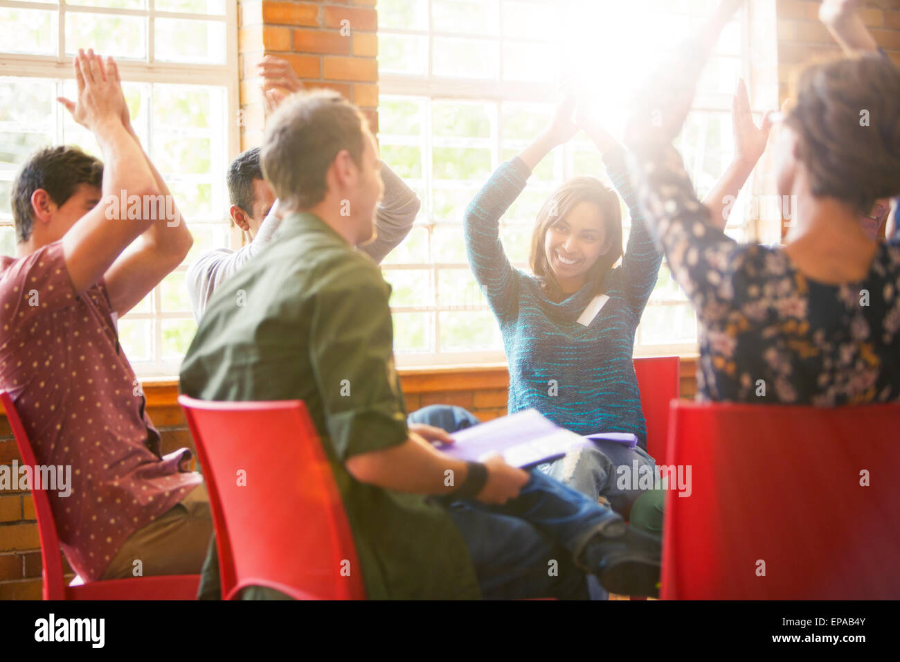 people clapping overhead group therapy Stock Photo - Alamy