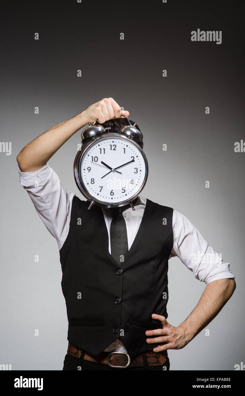 Businessman with clock in time concept Stock Photo - Alamy
