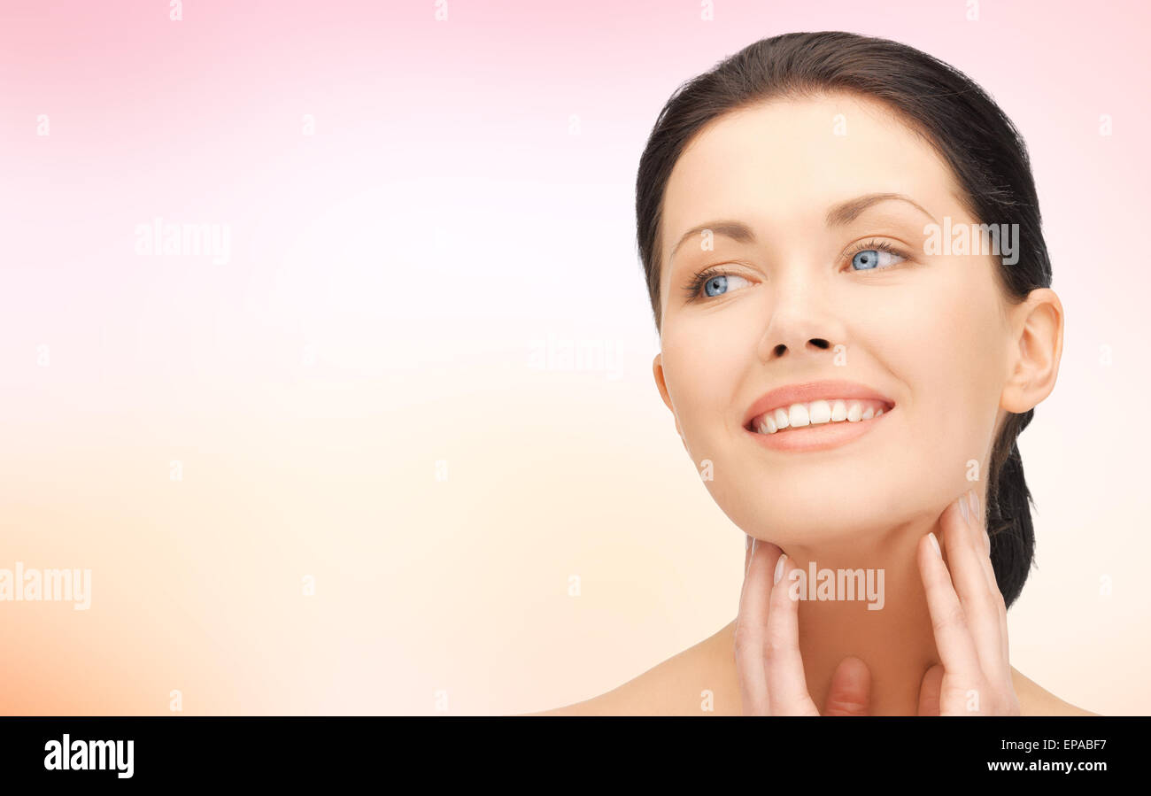beautiful young woman touching her face and neck Stock Photo - Alamy