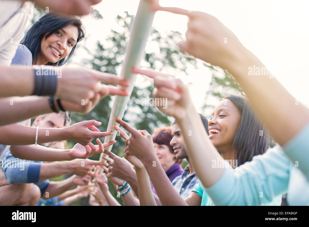 team balancing pole fingertip Stock Photo - Alamy