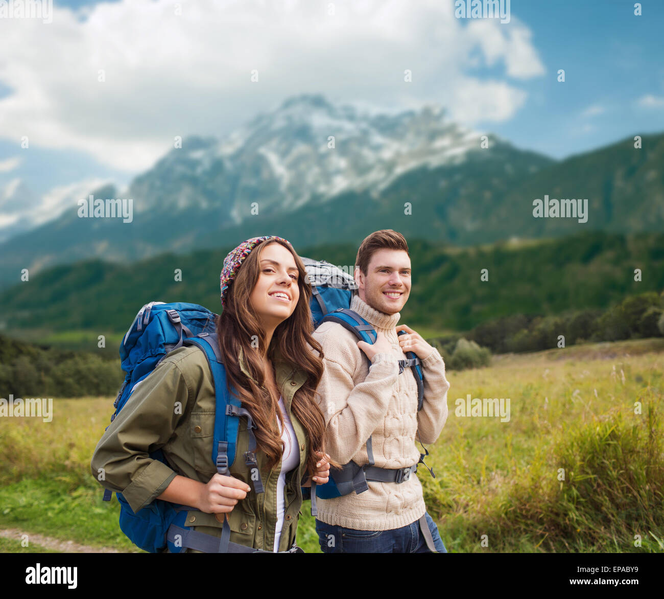 smiling couple with backpacks hiking Stock Photo - Alamy