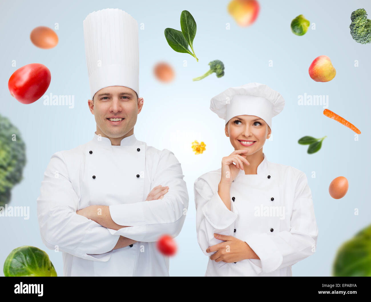 happy chef couple or cooks over food background Stock Photo - Alamy