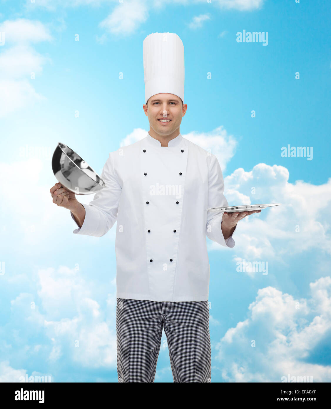 happy male chef cook opening cloche Stock Photo - Alamy