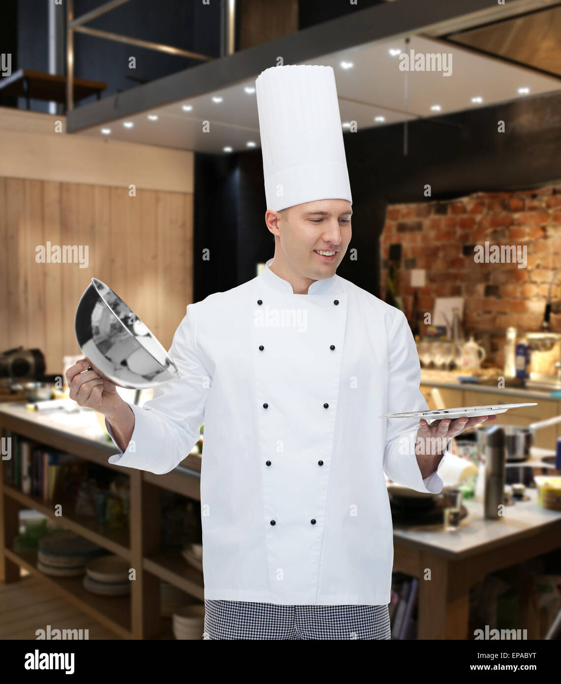 happy male chef cook opening cloche Stock Photo - Alamy