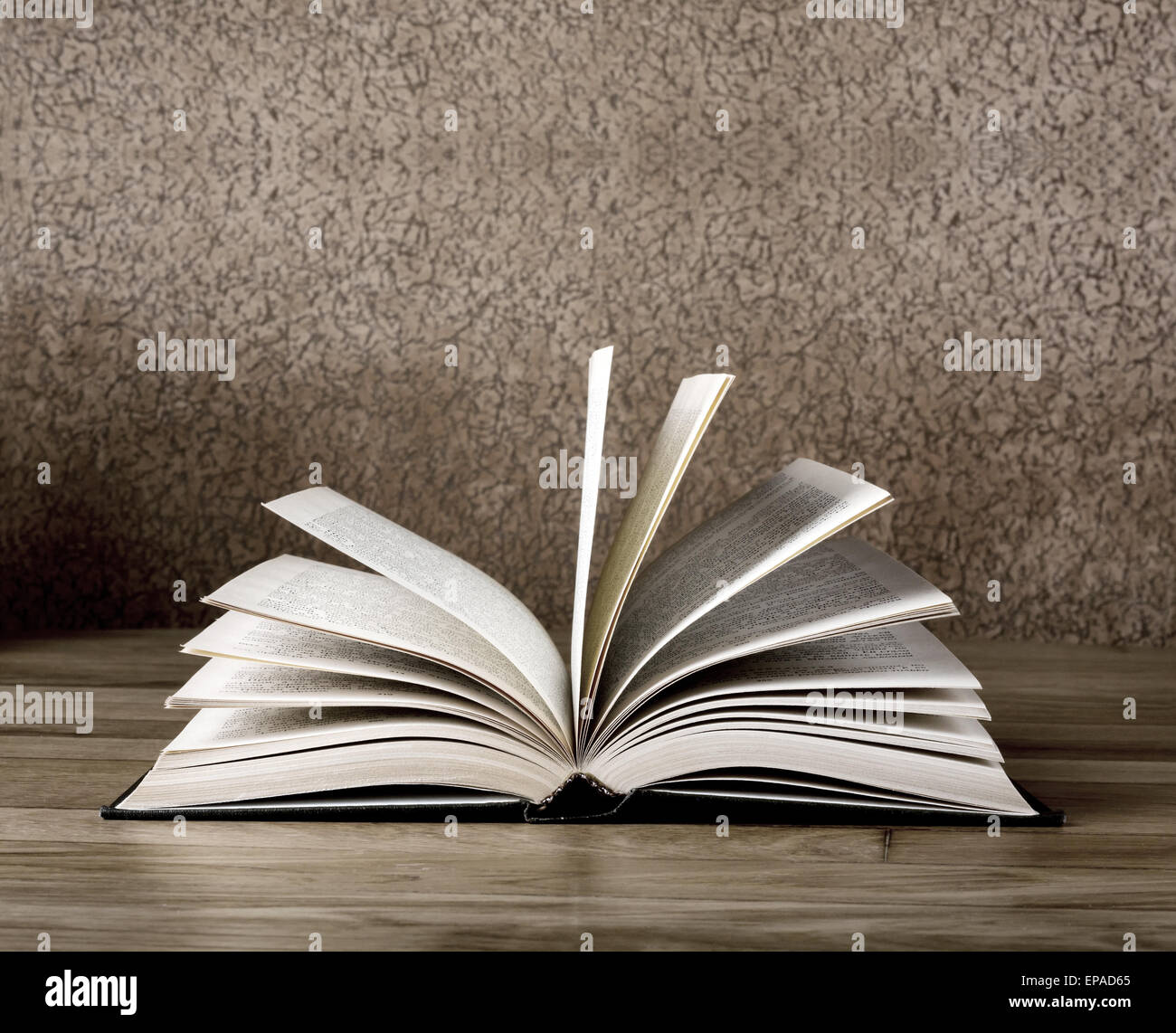Old open book on grunge wooden table Stock Photo - Alamy